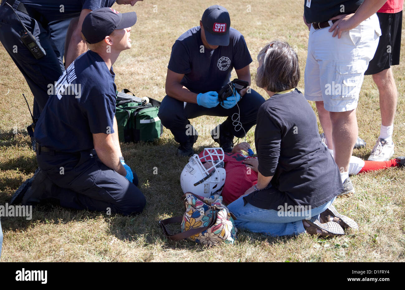 Nurse and paramedics attending to injured football player. Conway ...