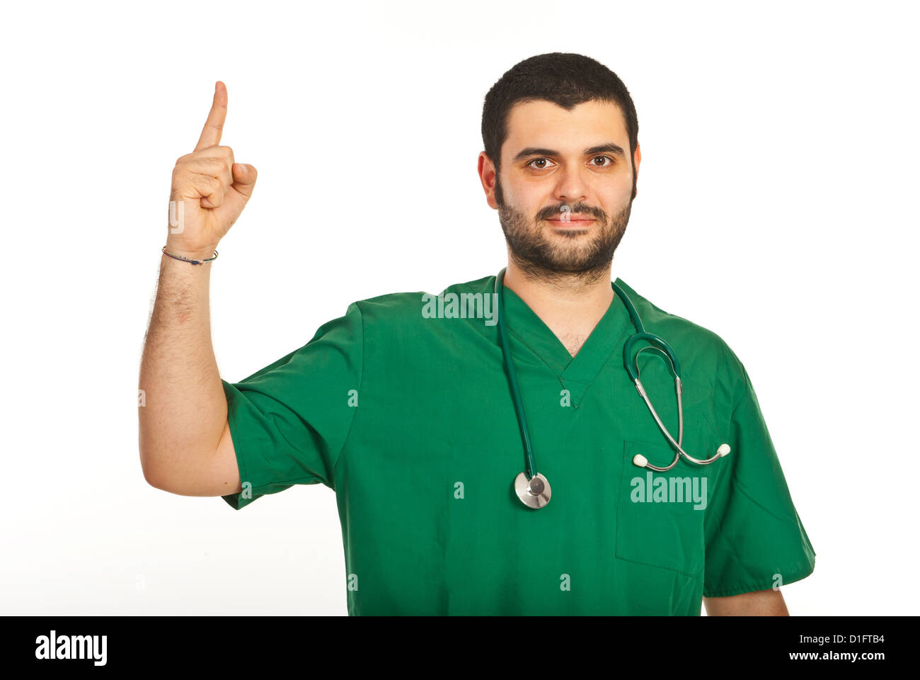 Doctor man in green uniform pointing up isolated on white background ...