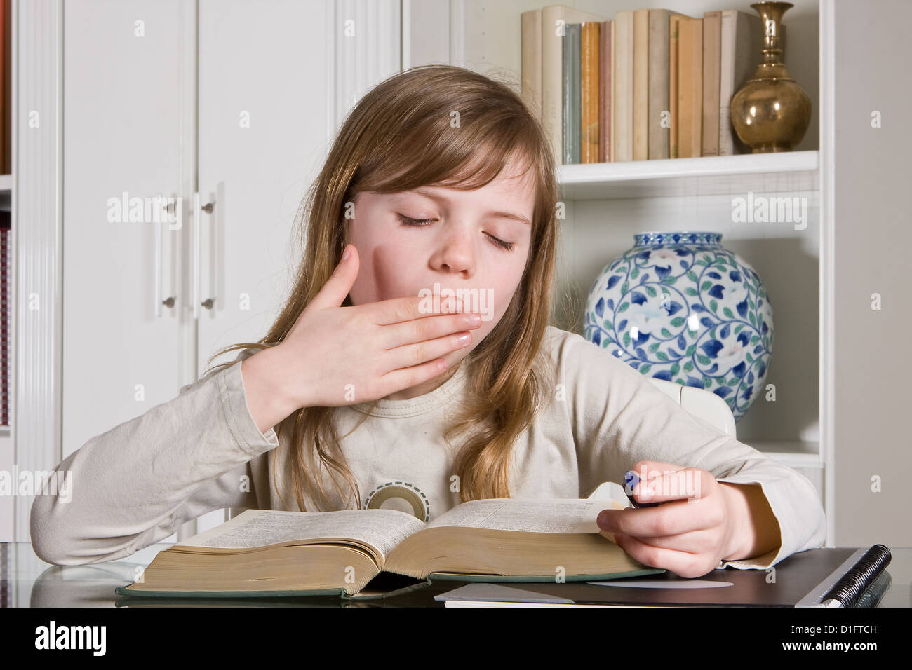 Young teenager girl studying a boring lesson Stock Photo - Alamy
