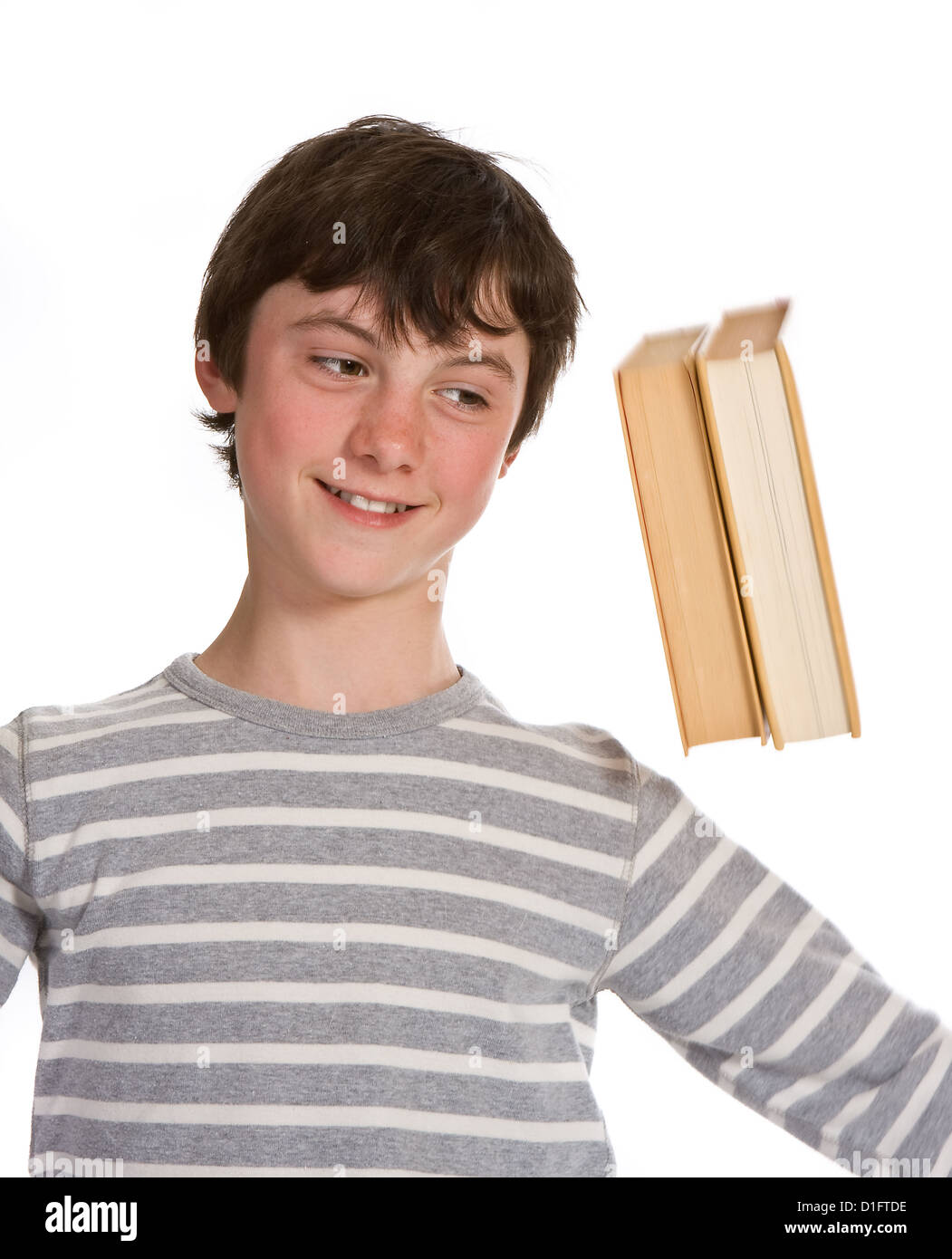 Teenager boy dropping two books from his head Stock Photo - Alamy