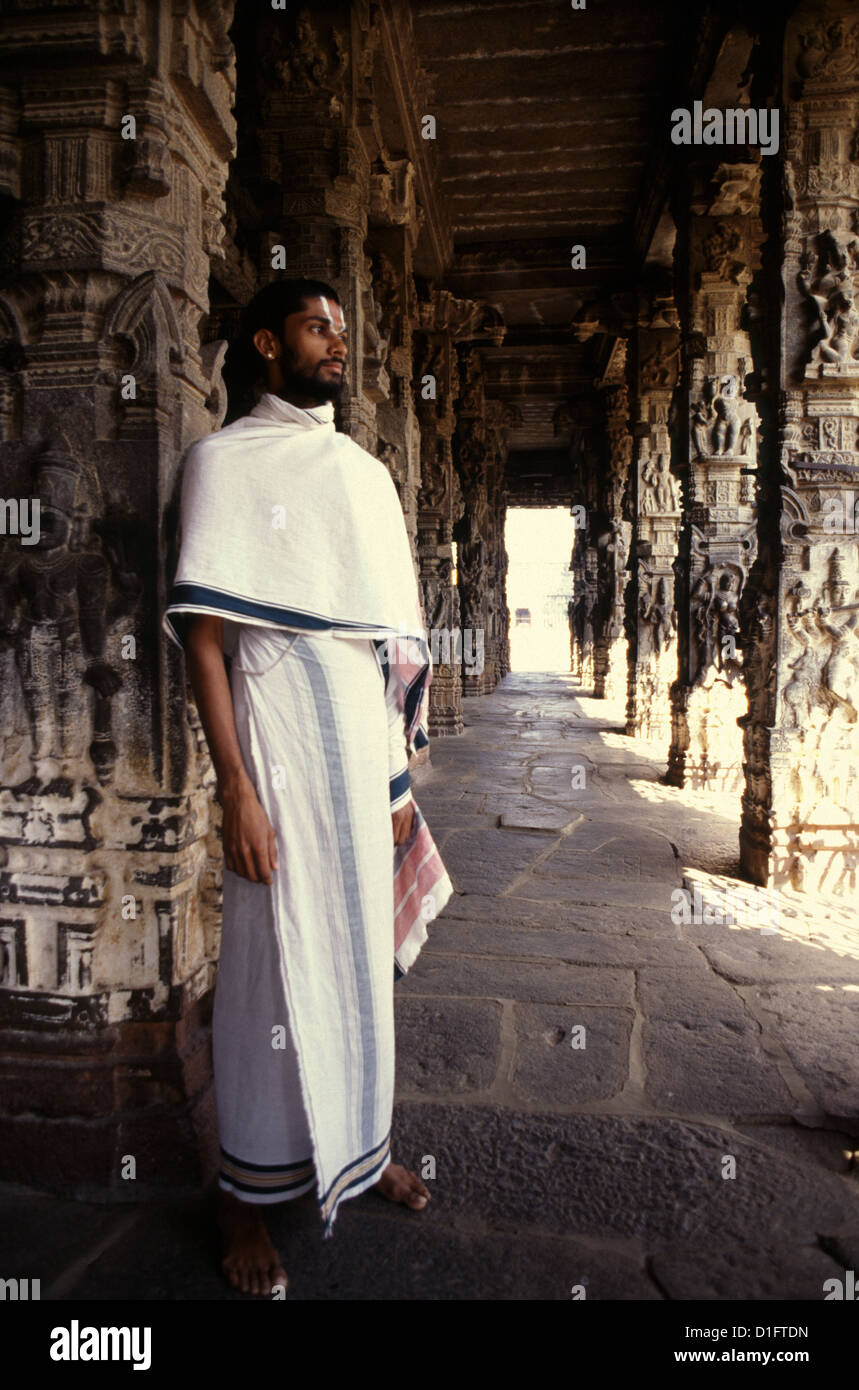 A Pujari or Hindu priest with Tilaka marking on his forehead stands at ...