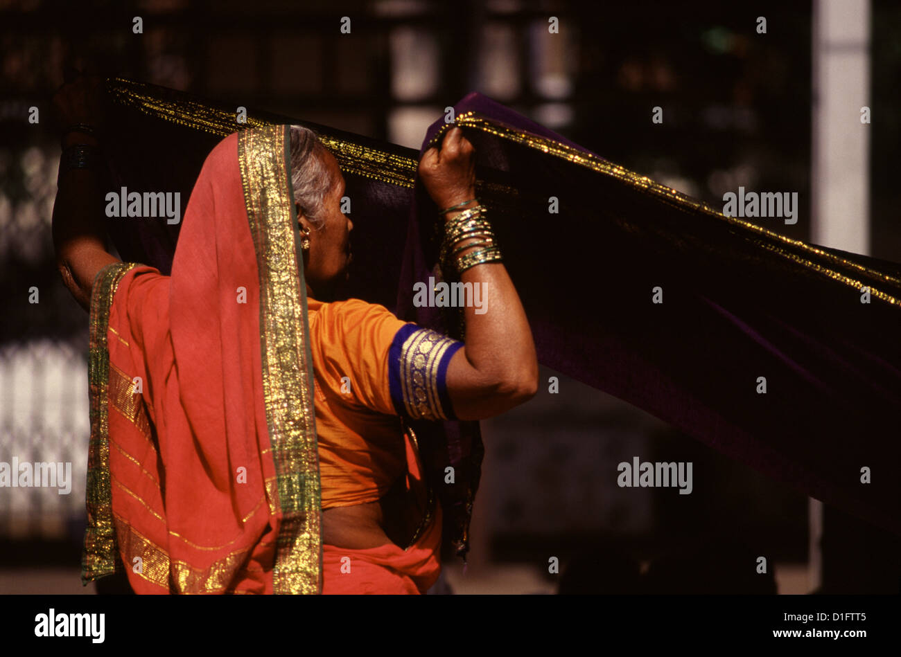 A woman drying Sari in the wind after bathing in the Ganges, Tamil Nadu ...