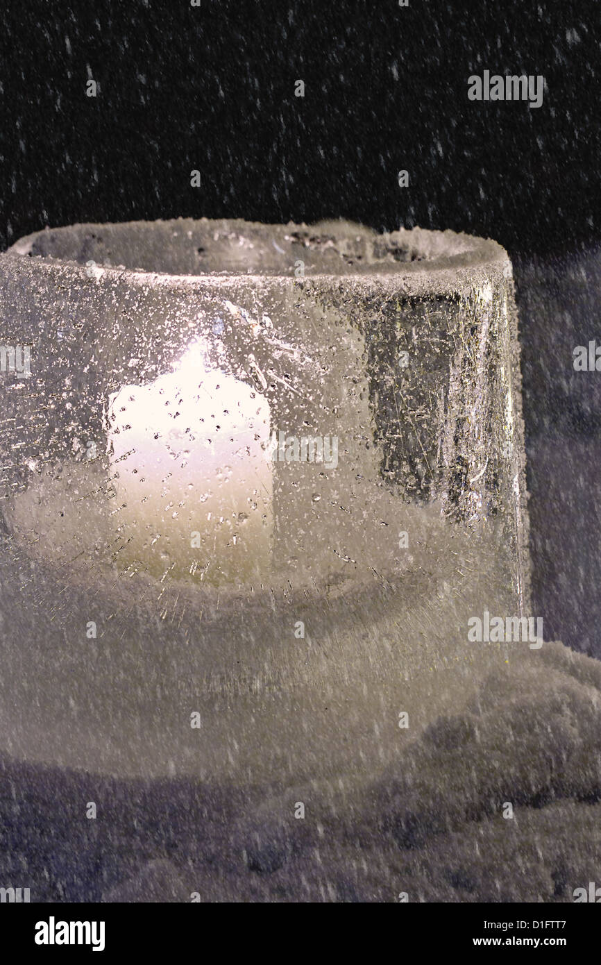 Winter lantern made of ice, burning candle inside Stock Photo - Alamy