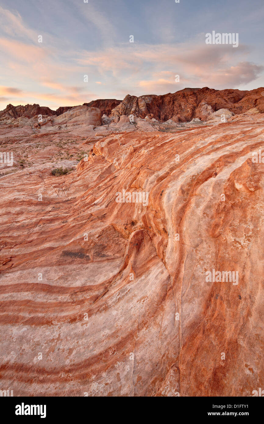 Orange and white sandstone layers with colorful clouds at sunrise ...