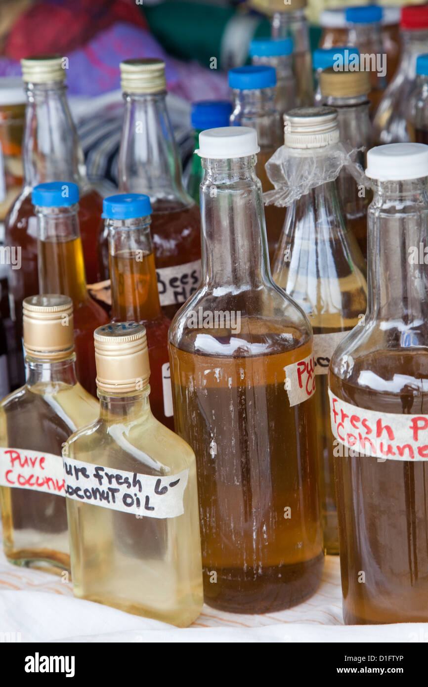 Bottles of coconut oil for sale at the San Ignacio market in Belize ...