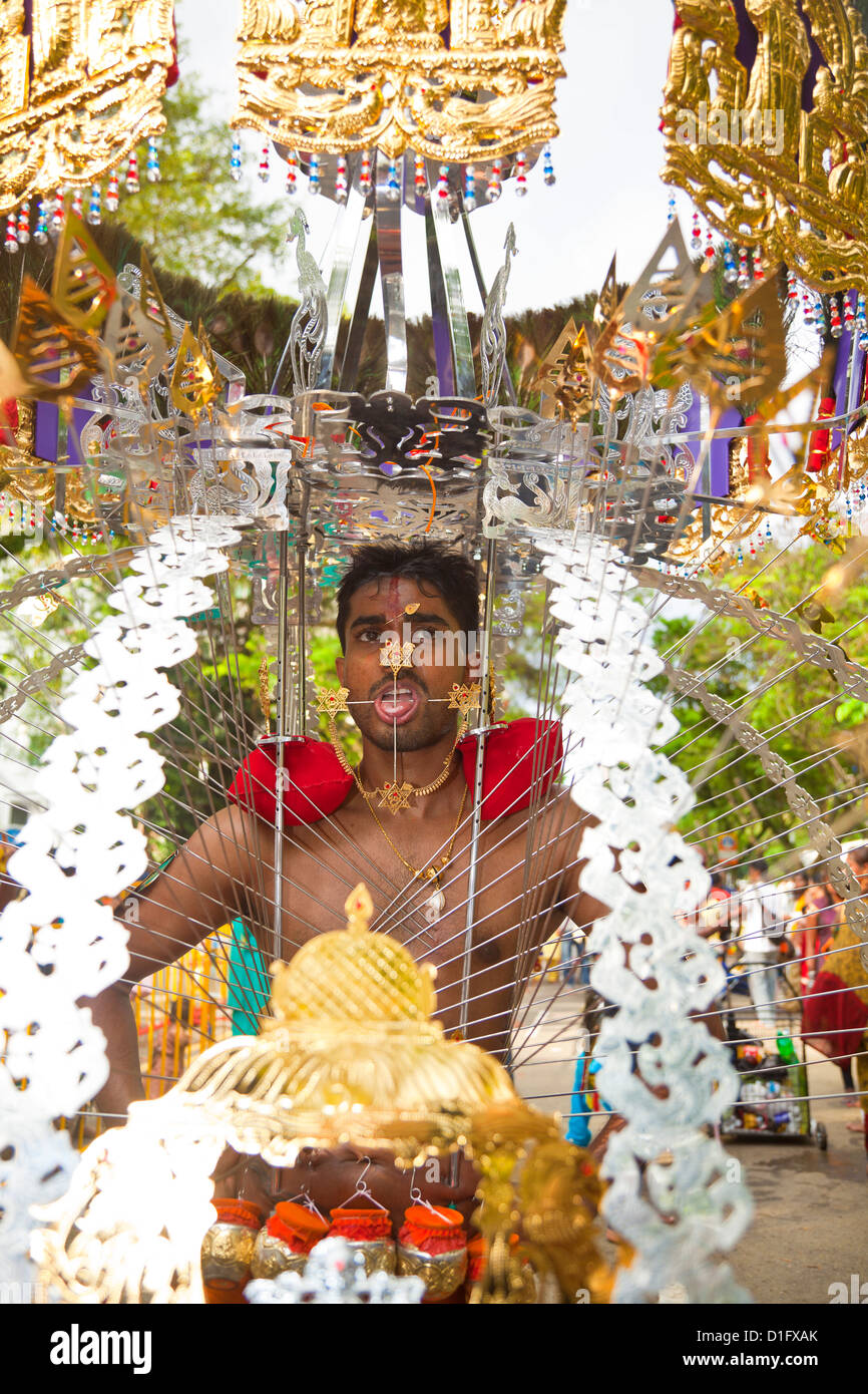 A Hindu devotee carrying portable shrine during Thaipusam in Singapore ...