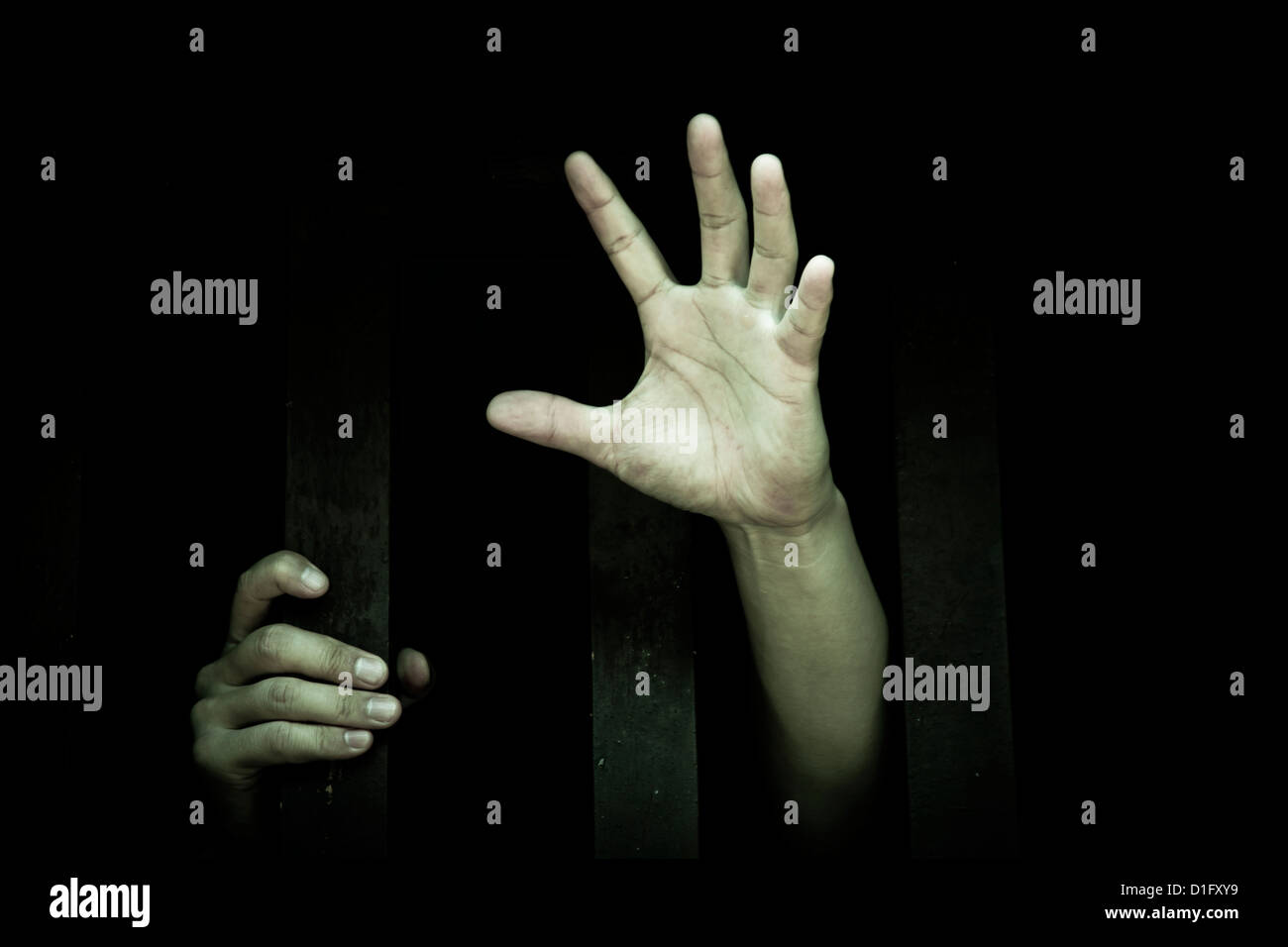 Prisoner gripping prison bars hi-res stock photography and images - Alamy