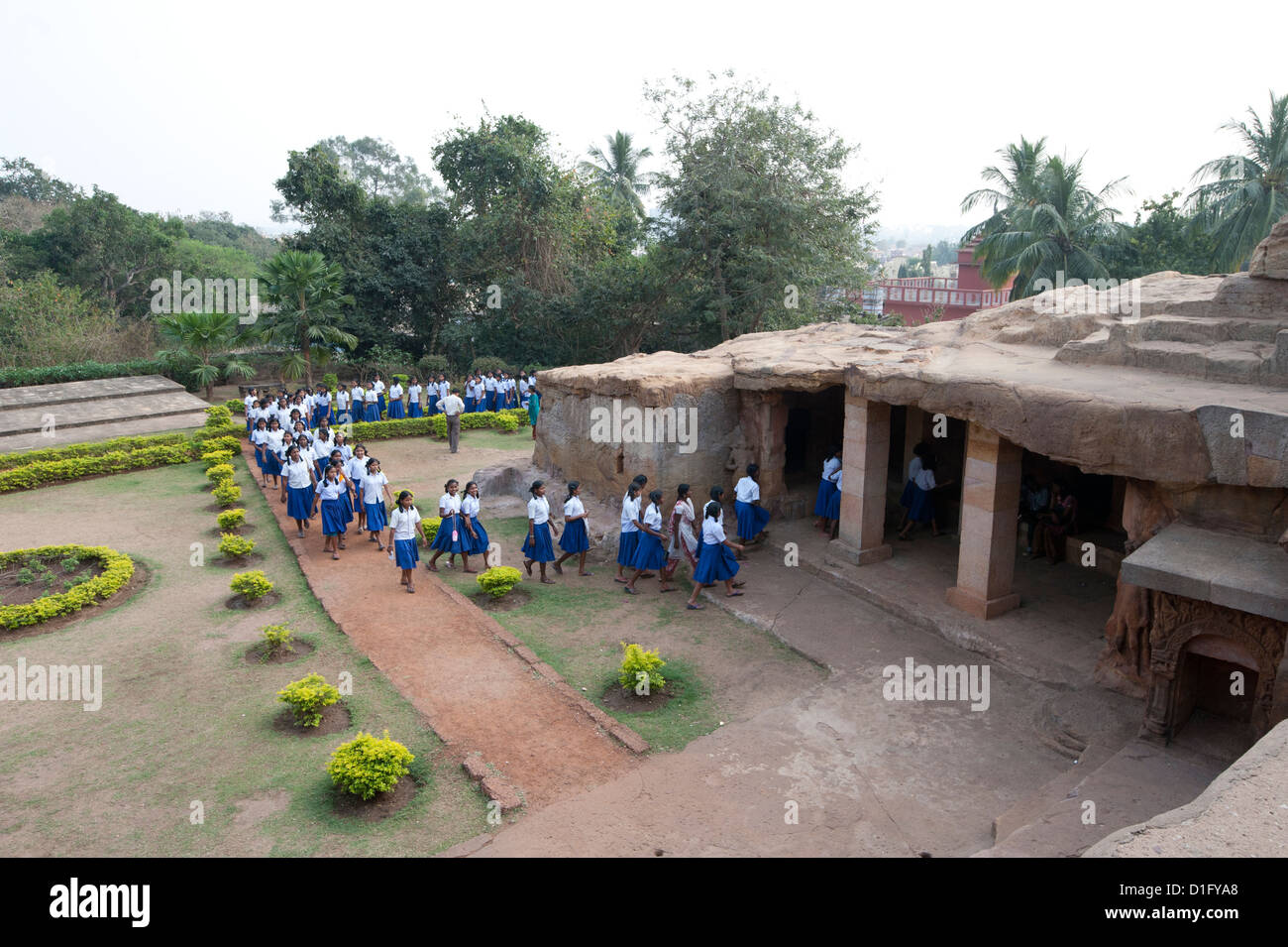 Local schoolchildren in school uniform visiting Ranigumpha, cave number ...