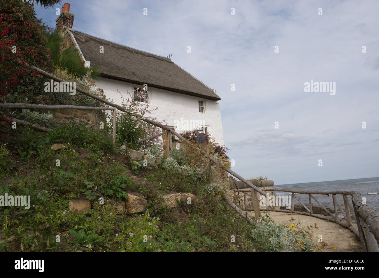 Thatched cottage by the sea Stock Photo - Alamy