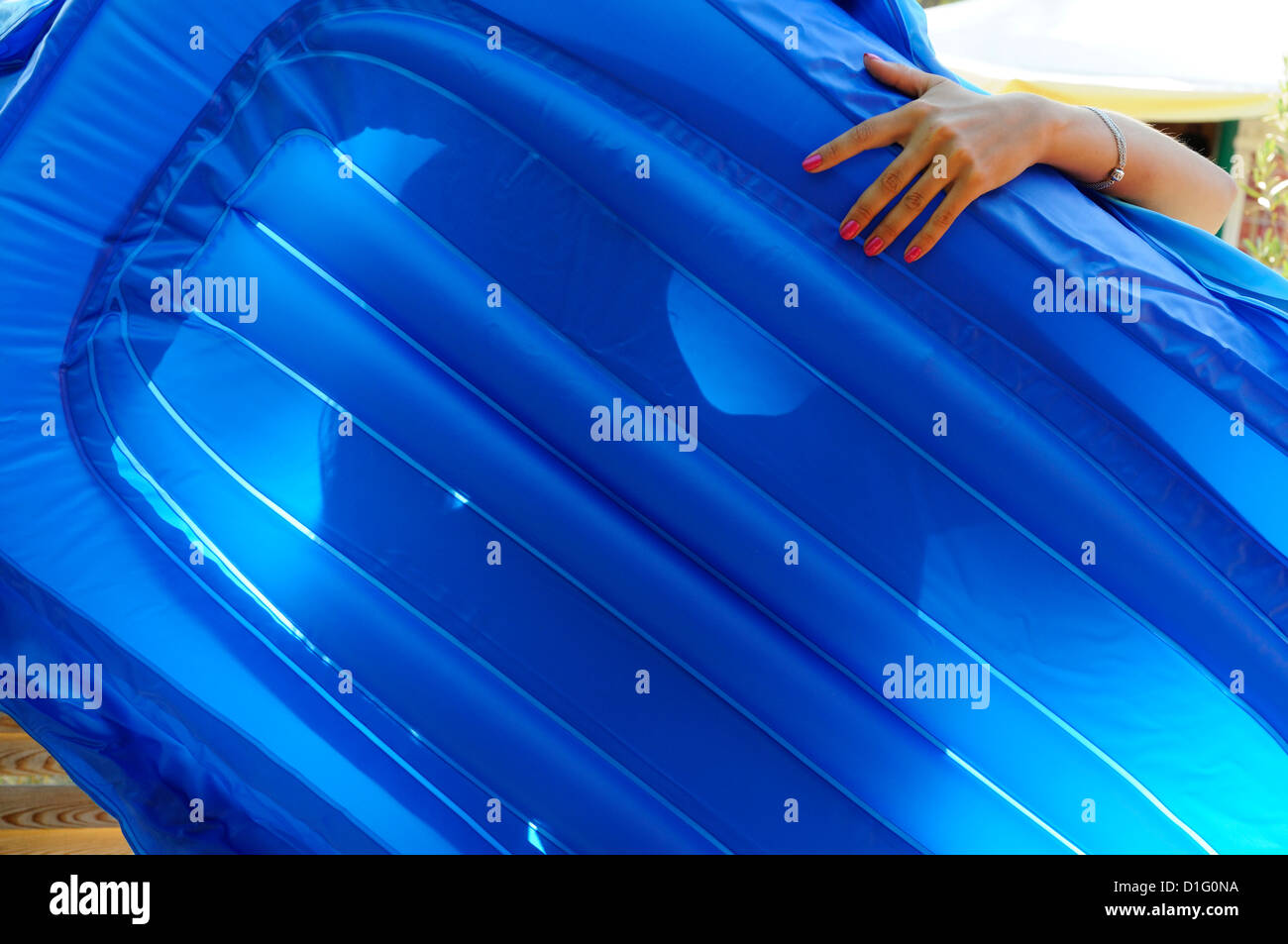 Stock photo of a girl blowing up an inflatable boat Stock Photo - Alamy