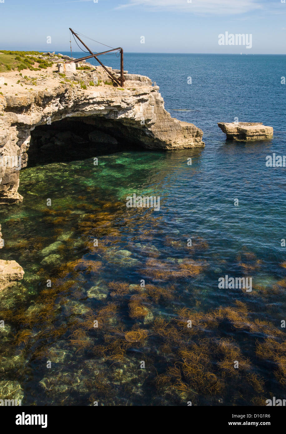 Boat crane above a shallow sea cave at Portland Bill Dorset on the ...