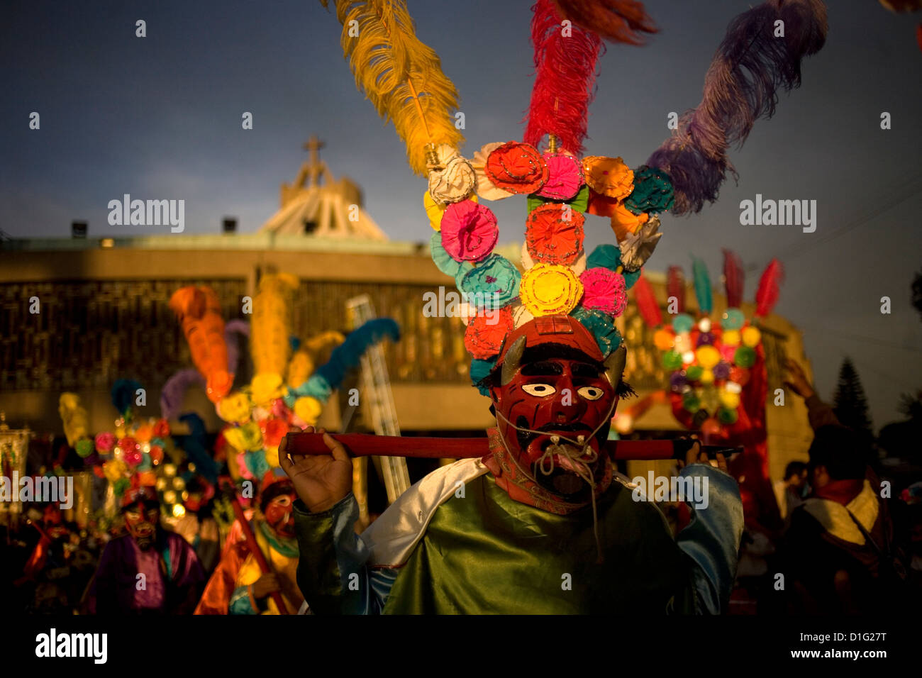 A pilgrim dressed as a red devil dances outside of the Our Lady of ...