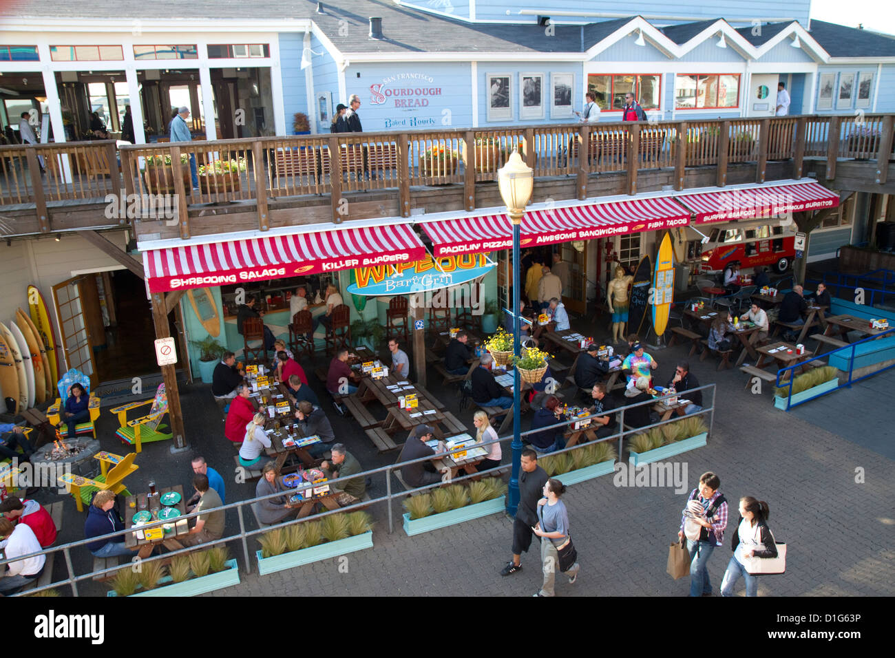 People dine outdoors at the Wipeout on Pier 39 in San Francisco ...