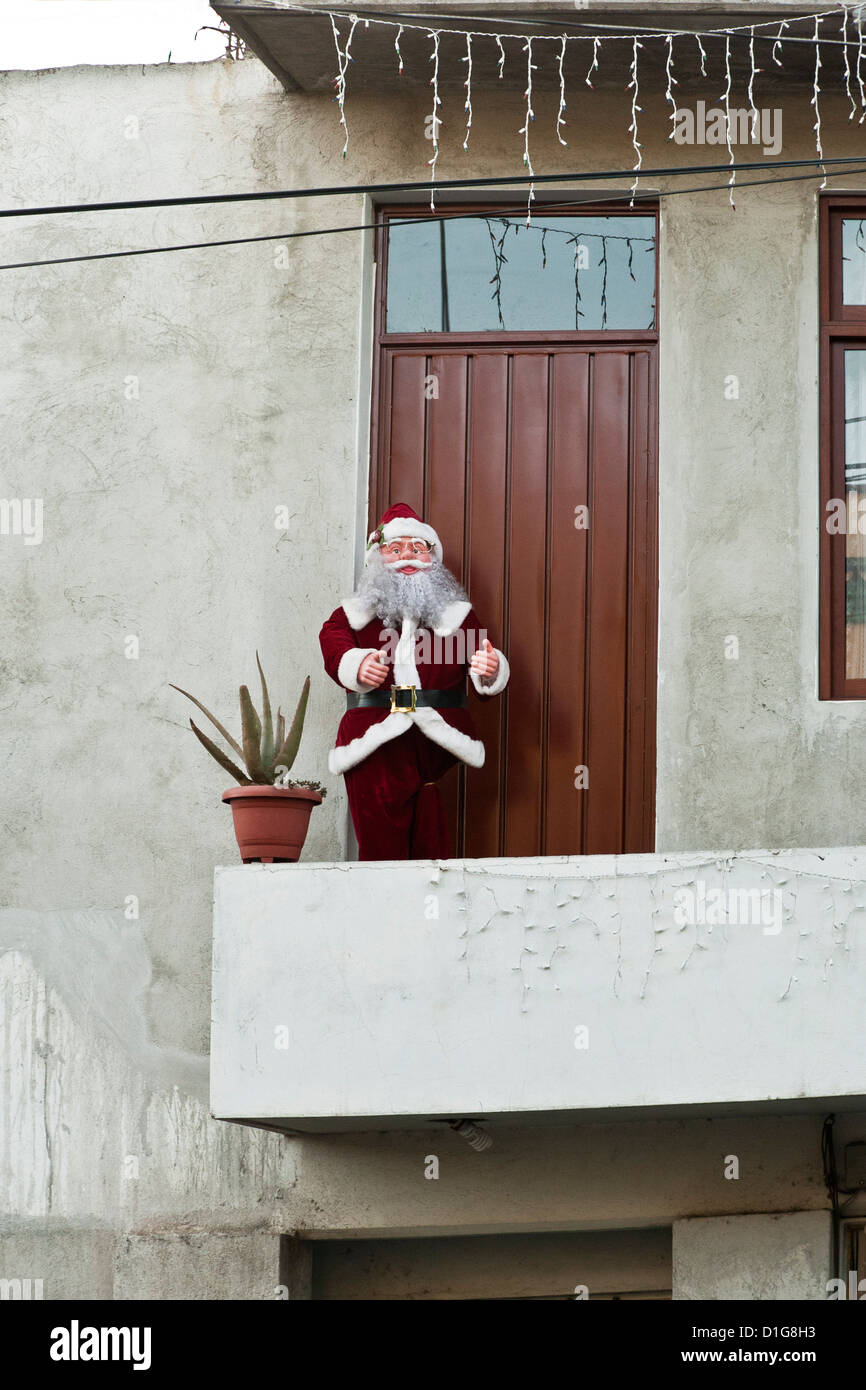 jolly plastic Santa figure with icicle lights & potted cactus decorate ...