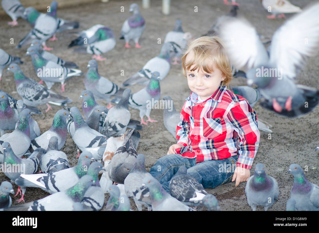 A Baby Smiling Surrounded by Doves Flying Around Stock Photo - Alamy