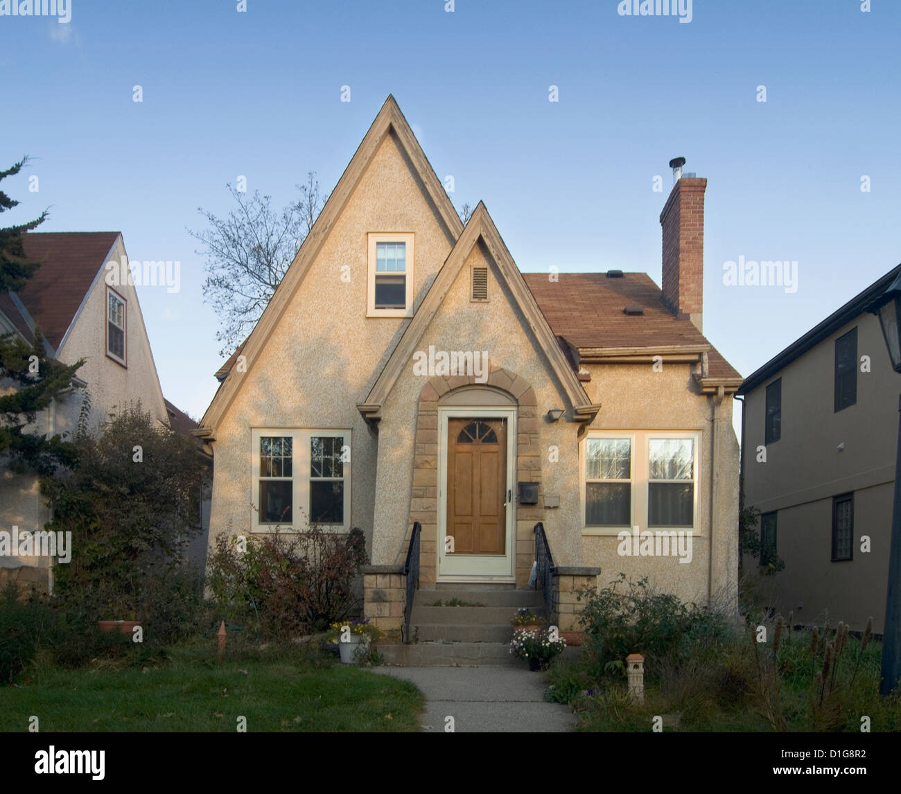 Exterior view of a beige cottage with angled roof tops; Minneapolis ...