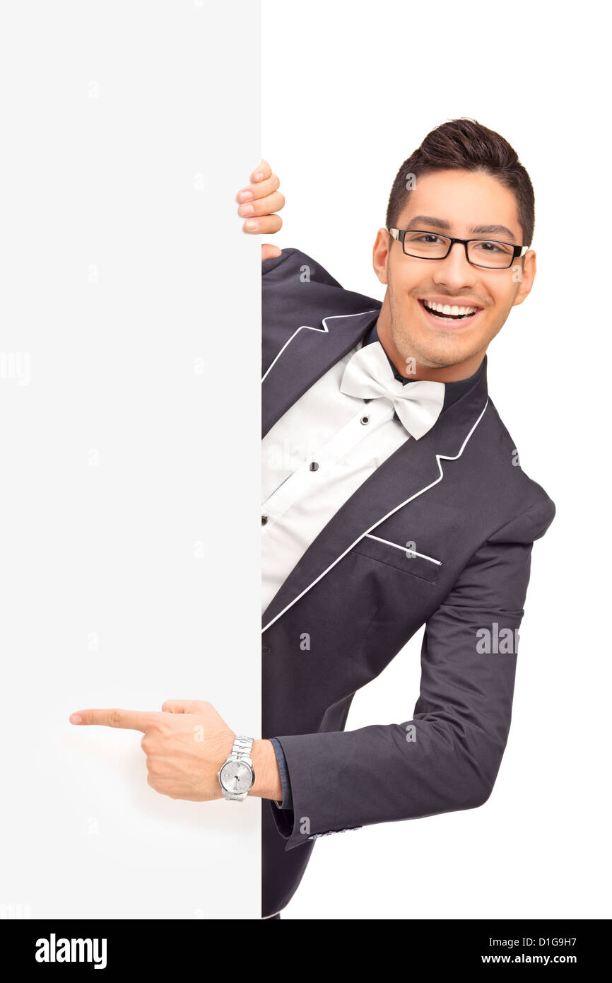 Stylish handsome guy pointing with finger on a blank panel isolated on ...
