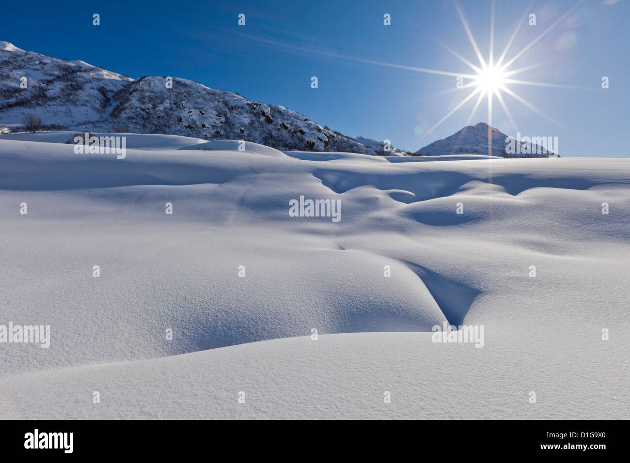 The late winter sun rises in the sky to illuminate the deep snow in the ...