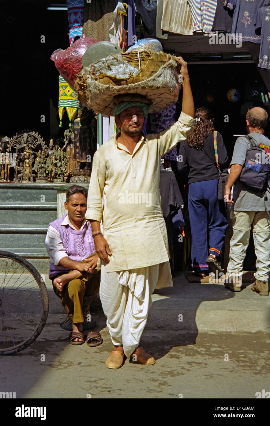 Street scene in Kathmandu Nepal with man carrying basket on head Stock ...