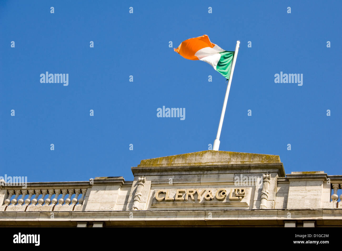 Horizontal view of the Irish national flag flying high above Clery & Co ...