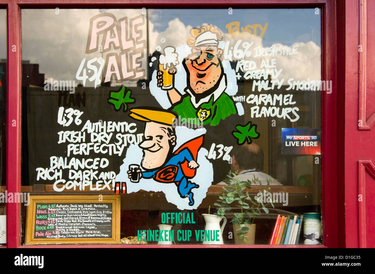 Horizontal close up of a pub window painted with fun cartoons in Dublin ...