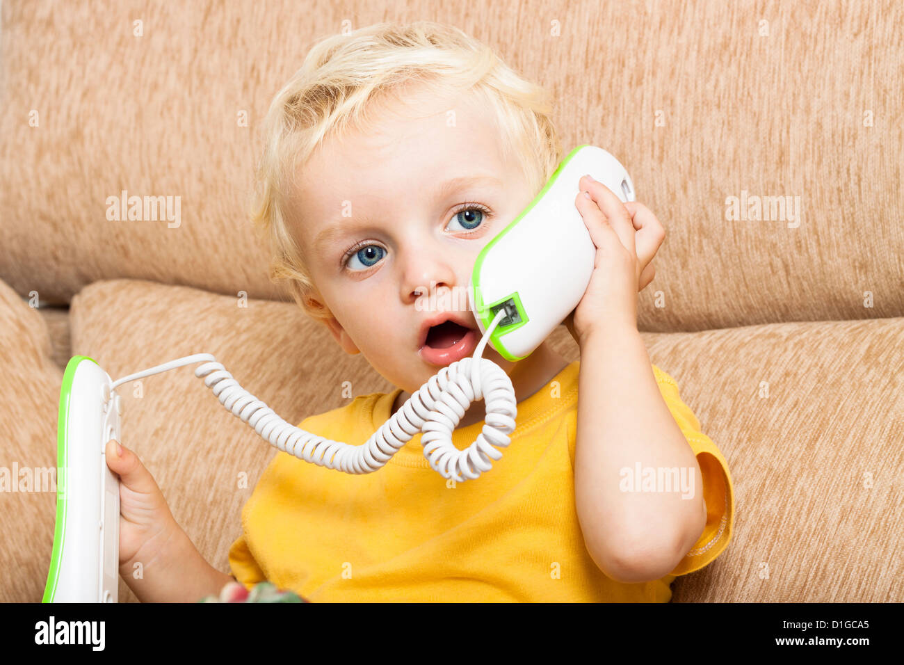 Close up of cute child boy using telephone Stock Photo - Alamy