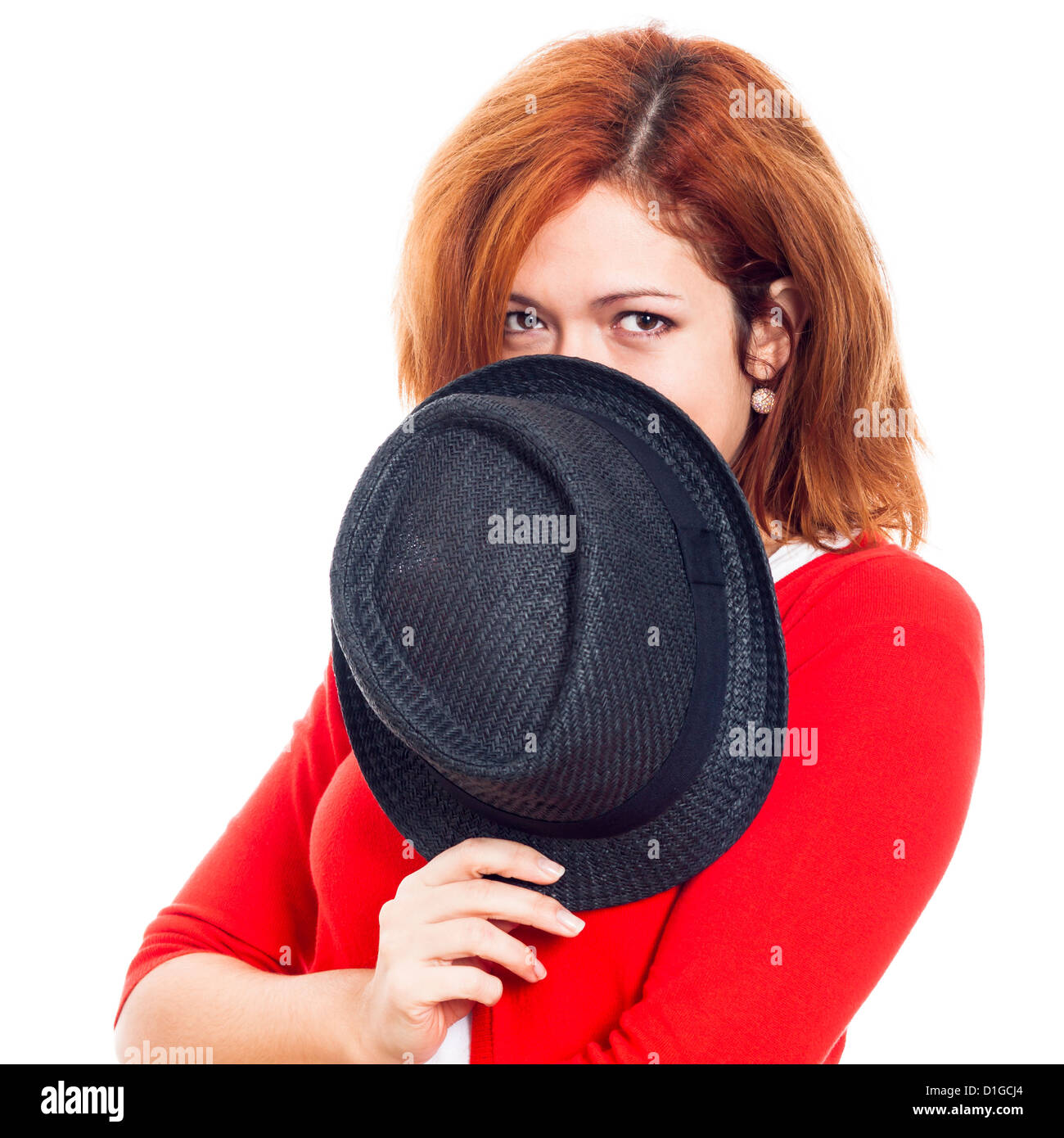 Young secret woman hiding face behind hat, isolated on white background ...
