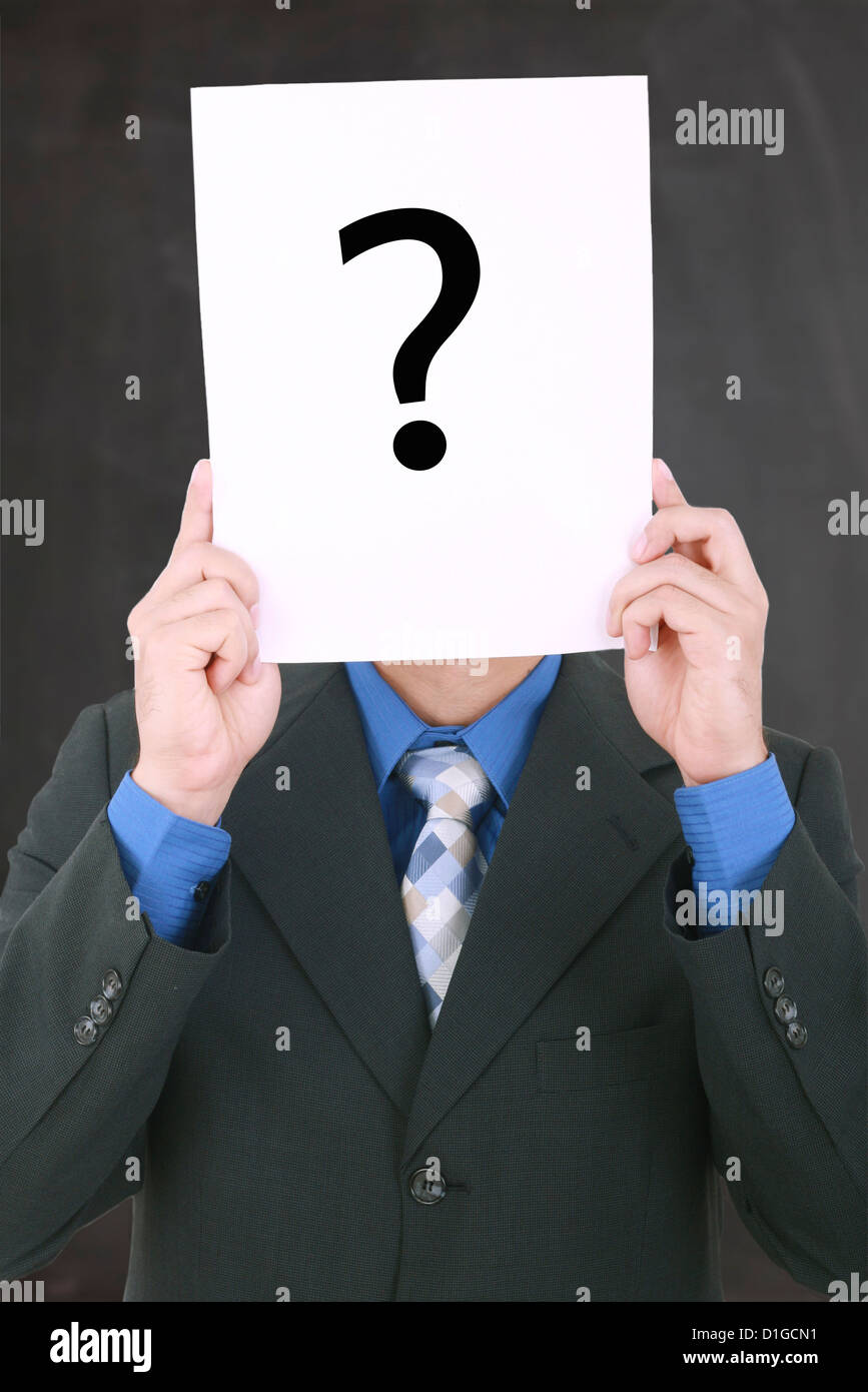 Young businessman holding a white billboard with a question mark on it ...