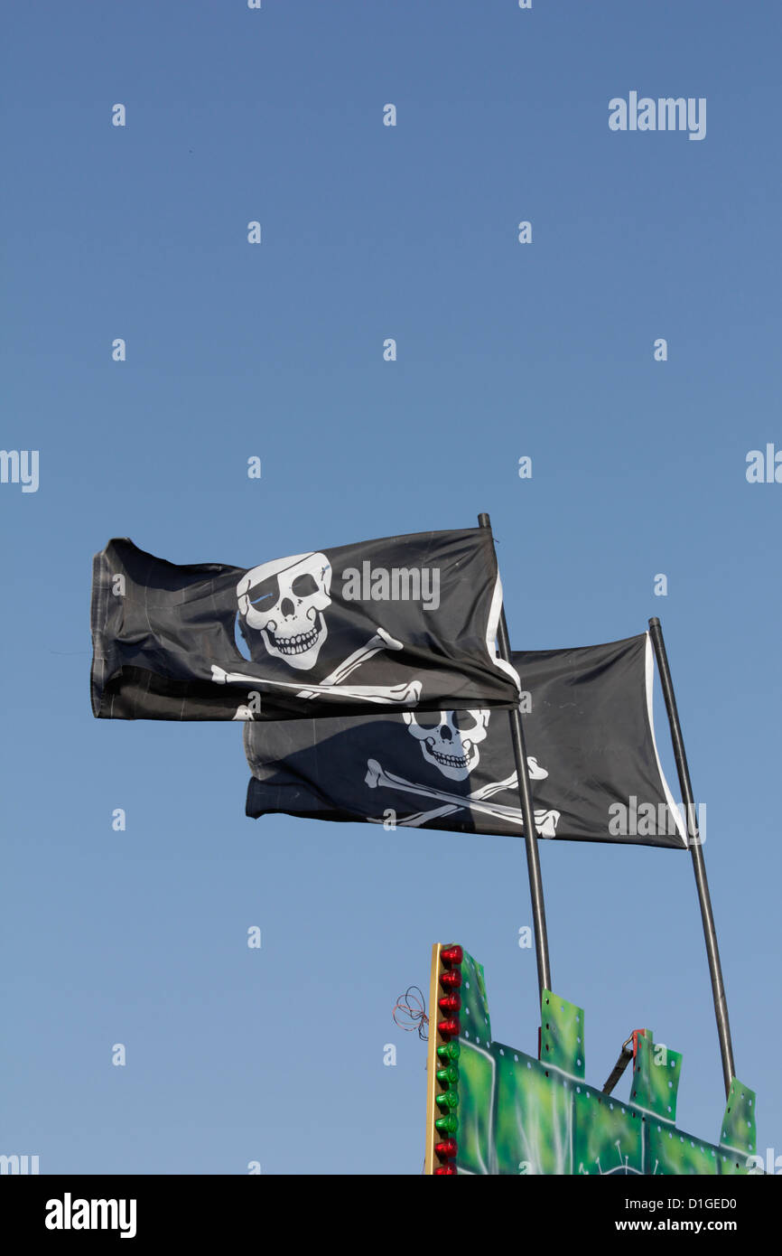 two pirate flags flying on fairground ride Stock Photo - Alamy
