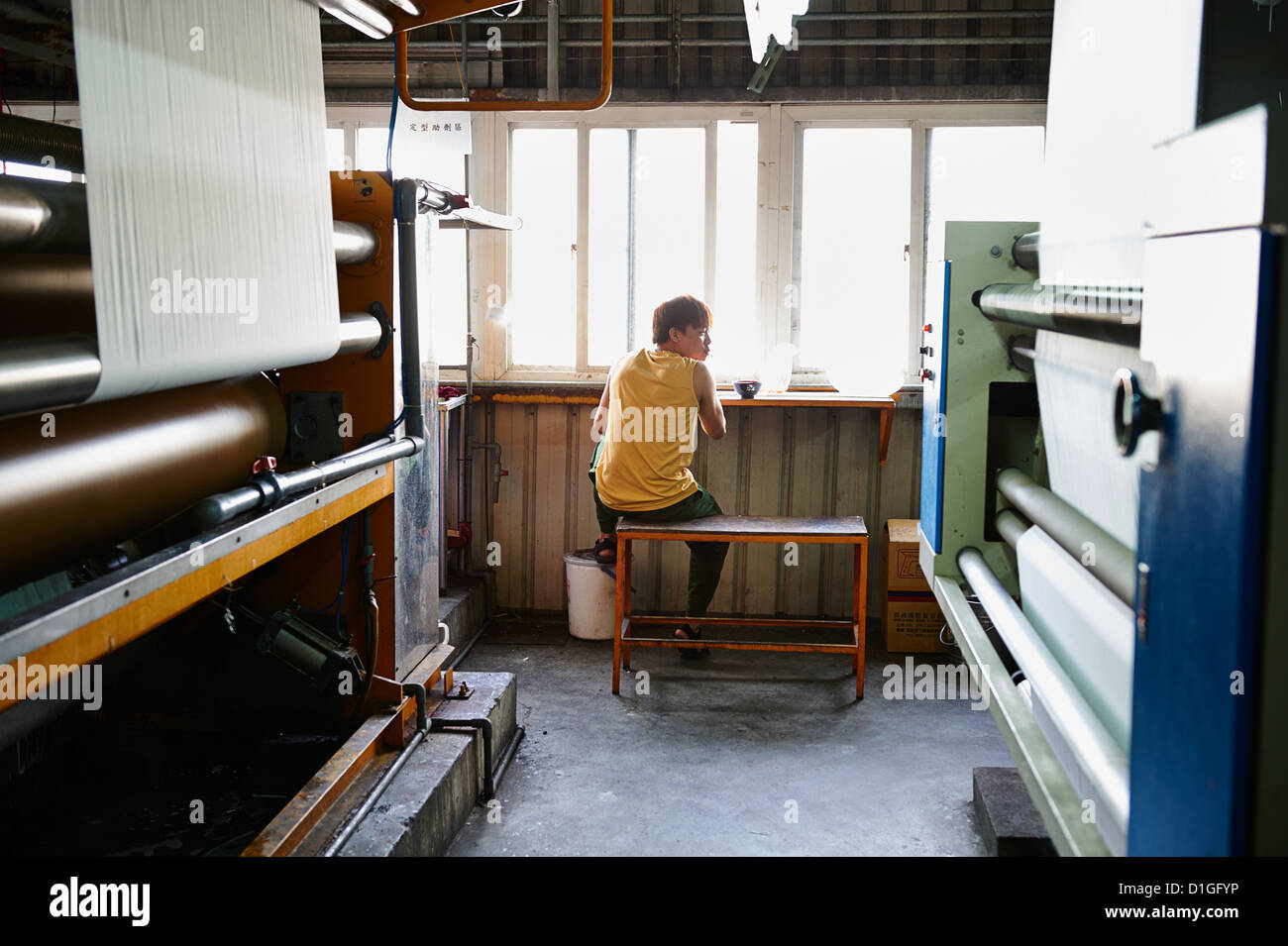 A worker enjoying a quiet lunch break near a window Stock Photo - Alamy