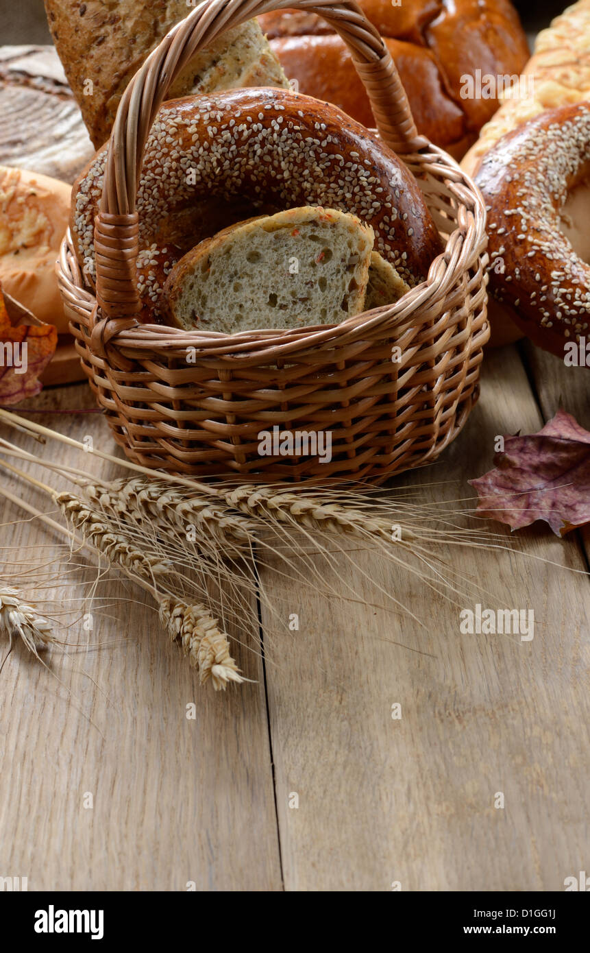 Group of bread loaves, buns, rolls on the wooden table Stock Photo - Alamy