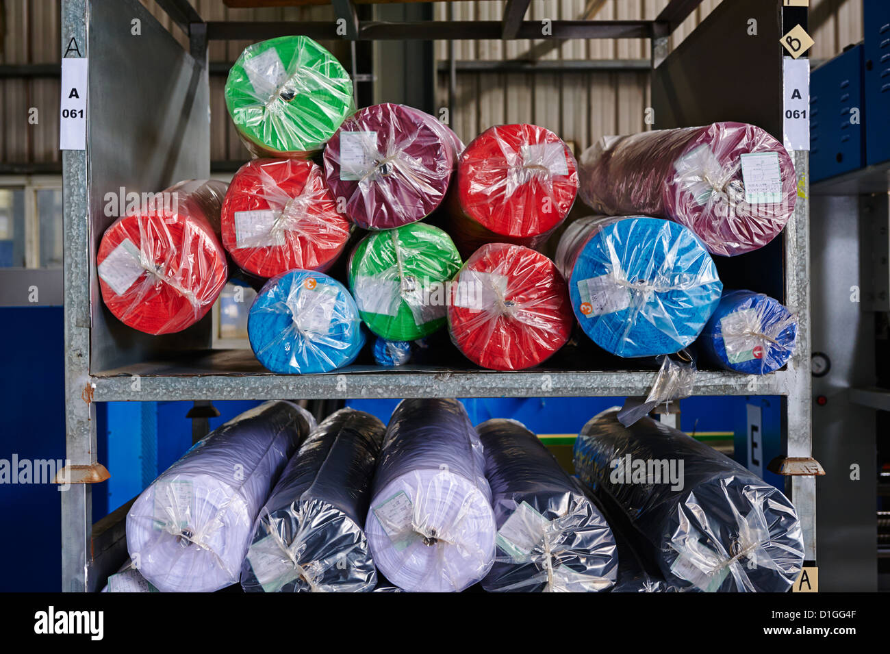 Color rolls of fabric in a textile factory Stock Photo - Alamy
