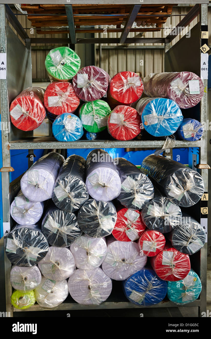 Color rolls of fabric in a textile factory Stock Photo - Alamy