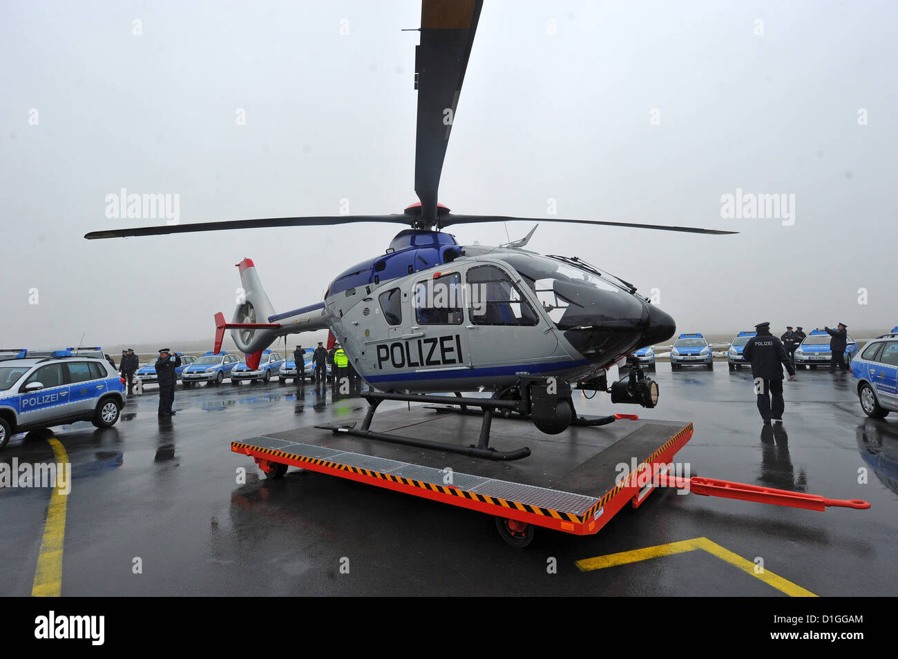 A police officer walks past the new EC 135 helicopter at the airport in ...