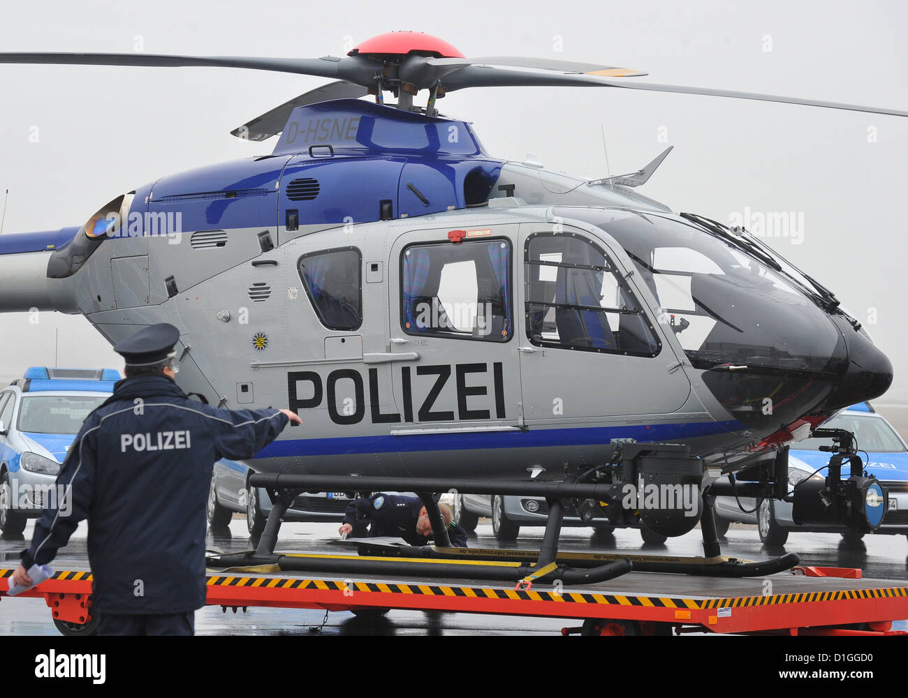 A police officer walks past the new EC 135 helicopter at the airport in ...