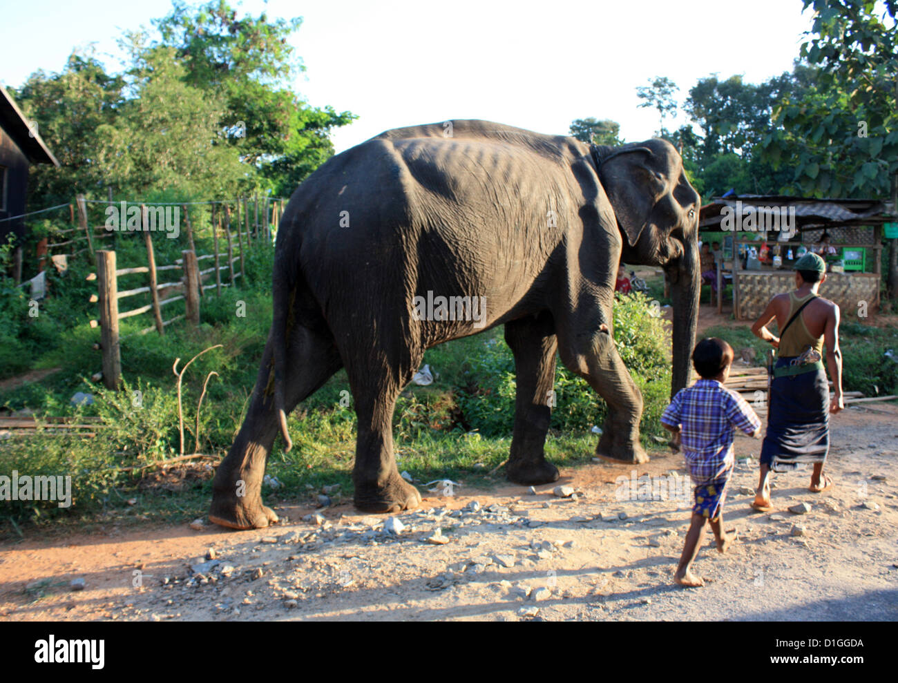 Local villagers walk through the streets of a small village with a ...