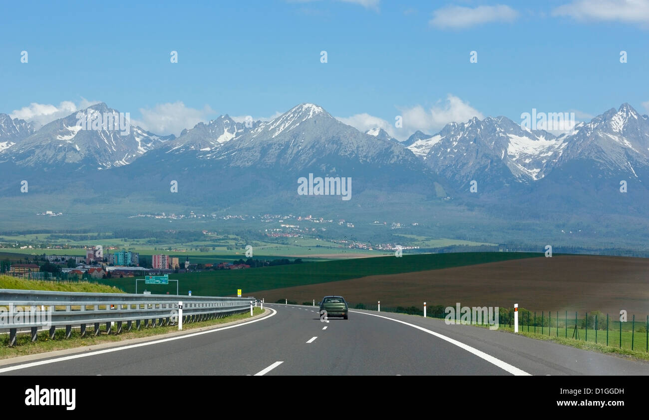 High Tatras spring view with snow on mountainside and highway (Slovakia ...