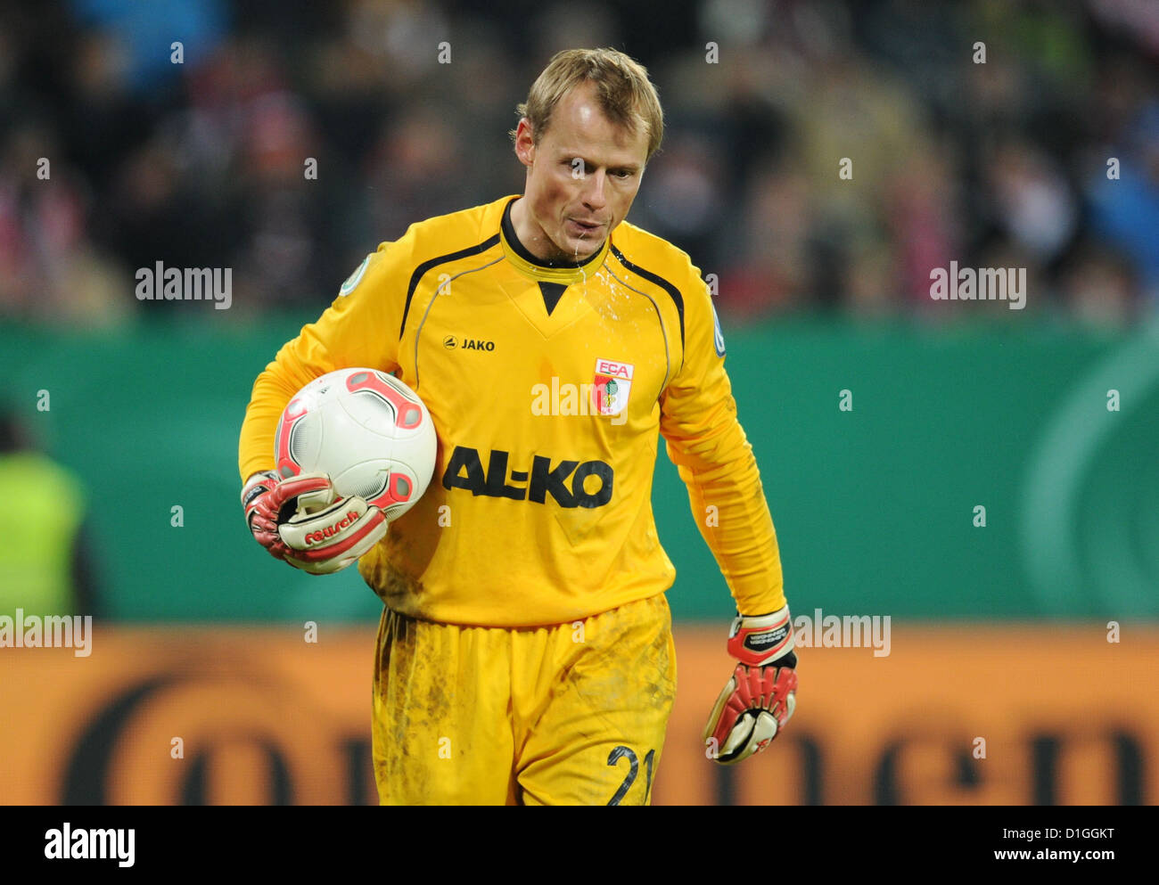Augsburg's goalkeeper Alex Manninger holds the ball during the DFB Cup ...