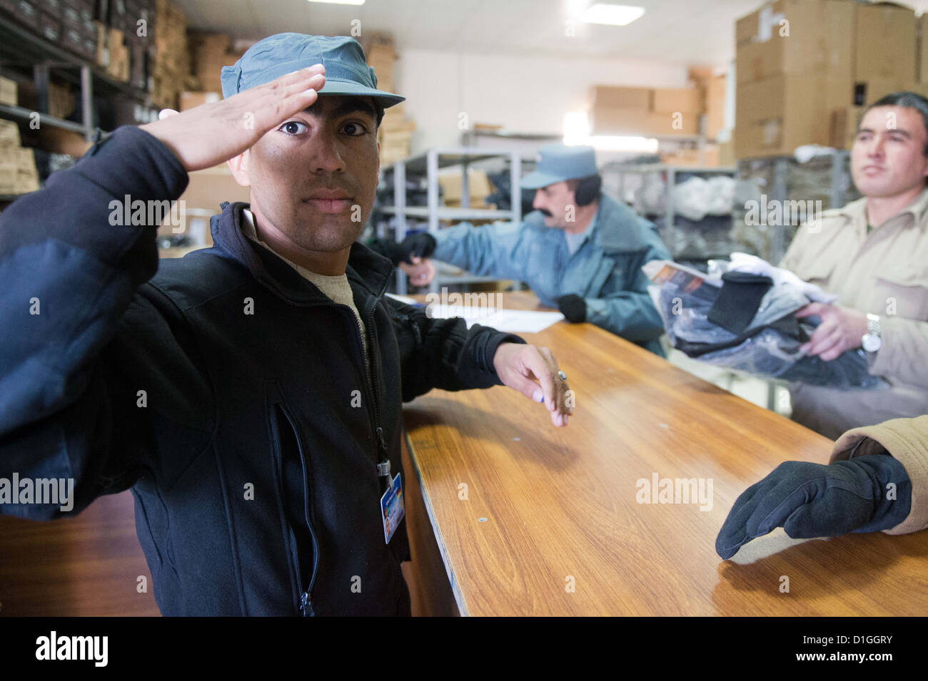 A Afghanistan National Police (ANP) officer salutes after receiving his ...