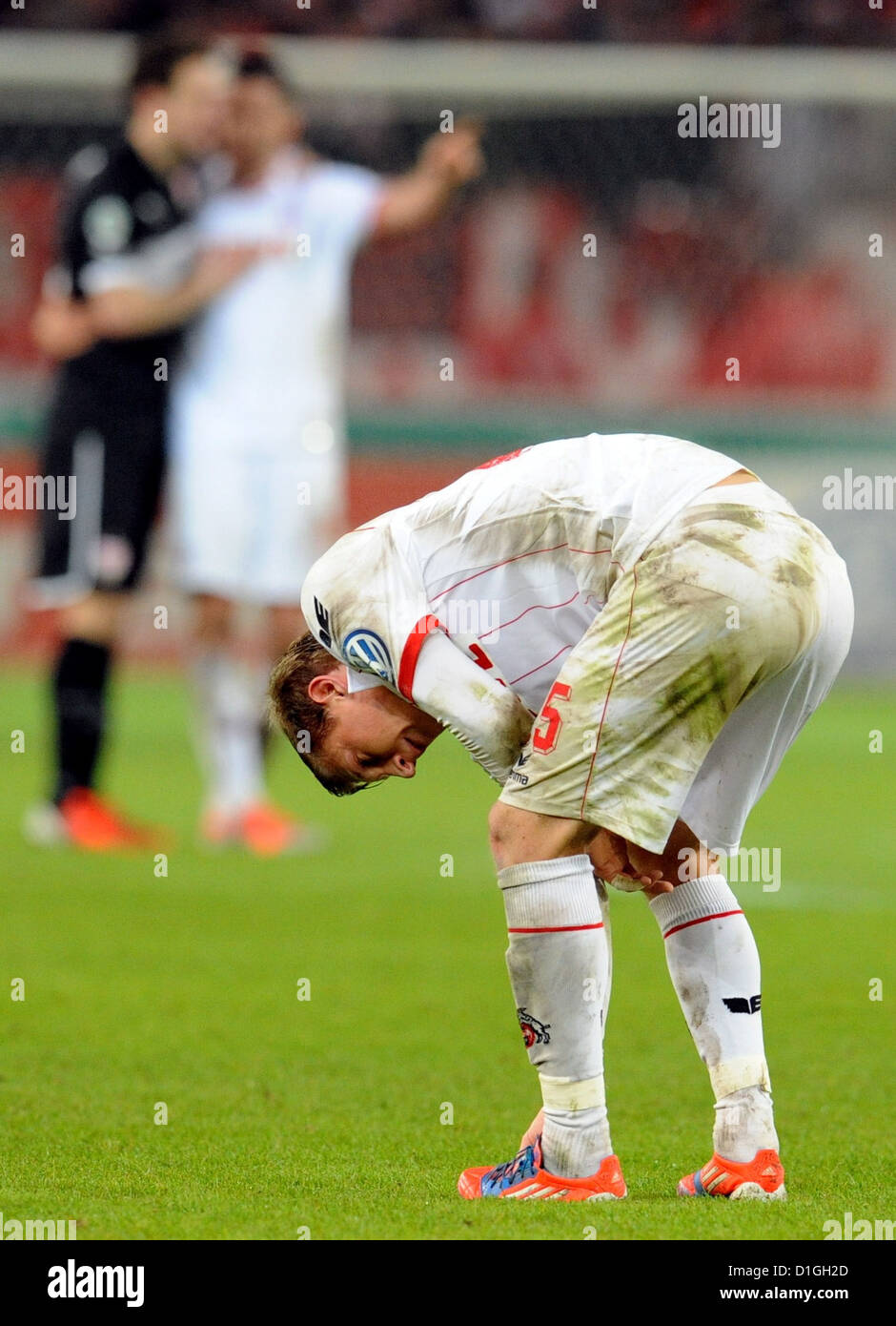 Cologne's player Daniel Royer bends forwards taking a deep breath as he ...