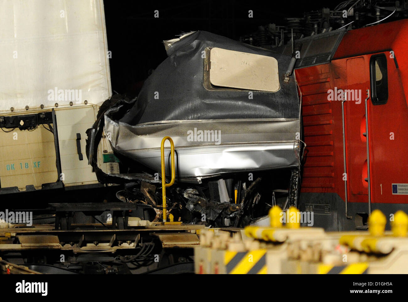 A bus (C, silver) is stuck between two fright trains after an accident ...