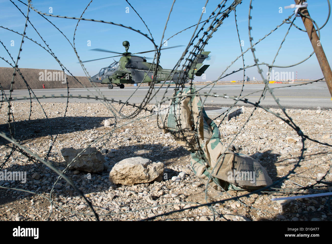 A Tiger combat helicopter stands behind barbed wire on stand-by on a ...