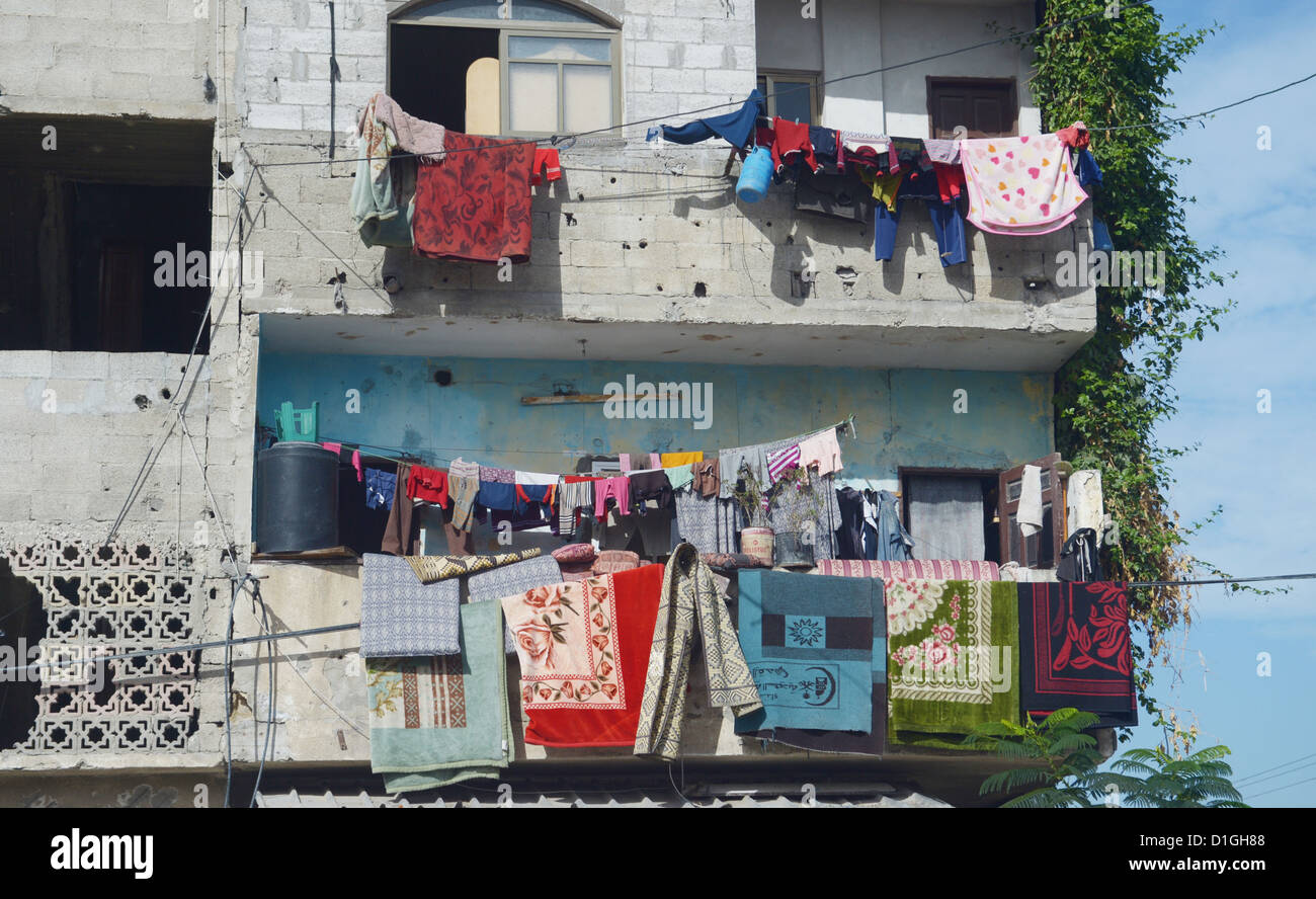 Laundry and wollen blankets hang on washing lines from balconies of a ...