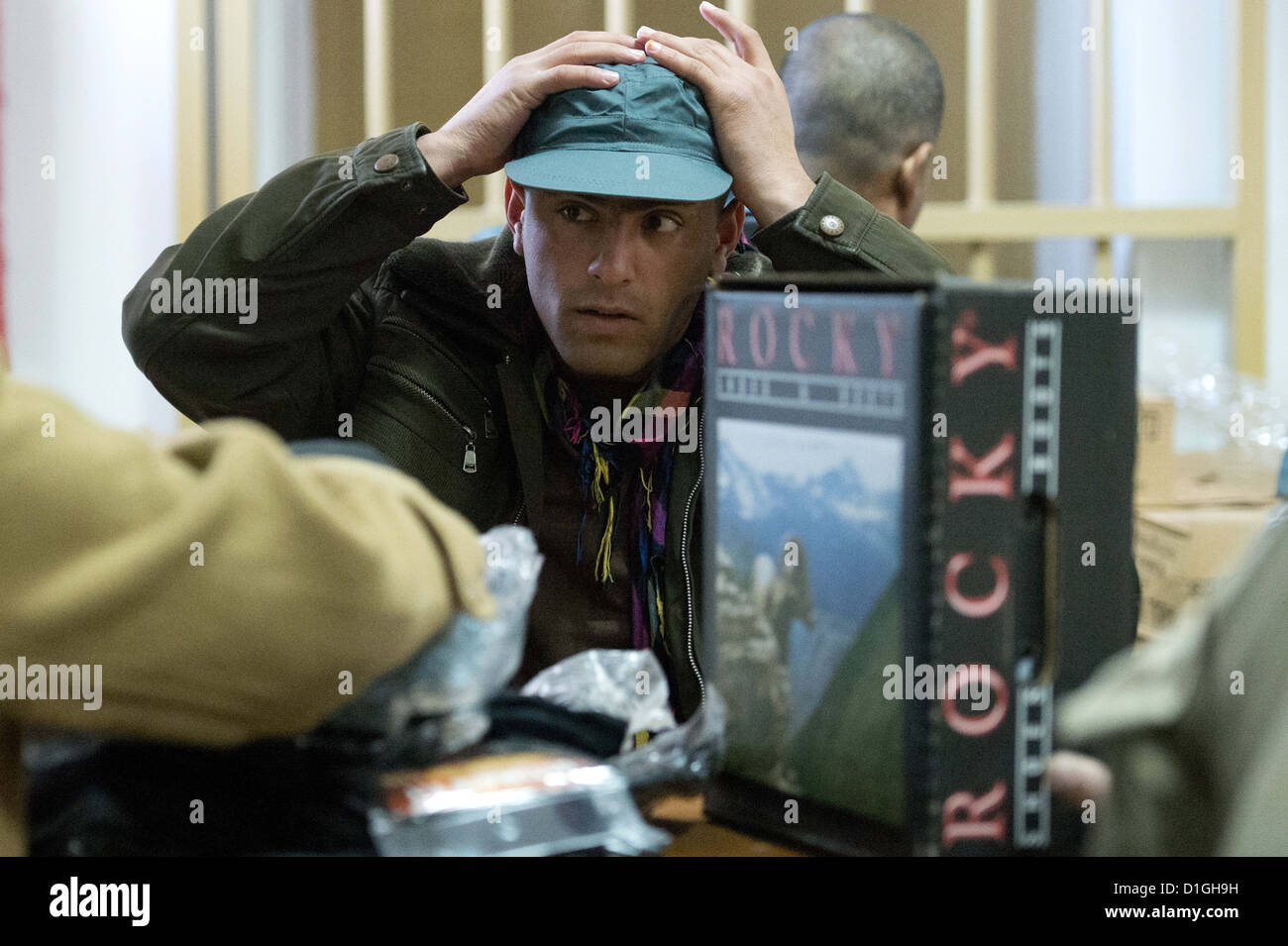An Afghanistan National Police (ANP) officer tries on a new cap at the ...