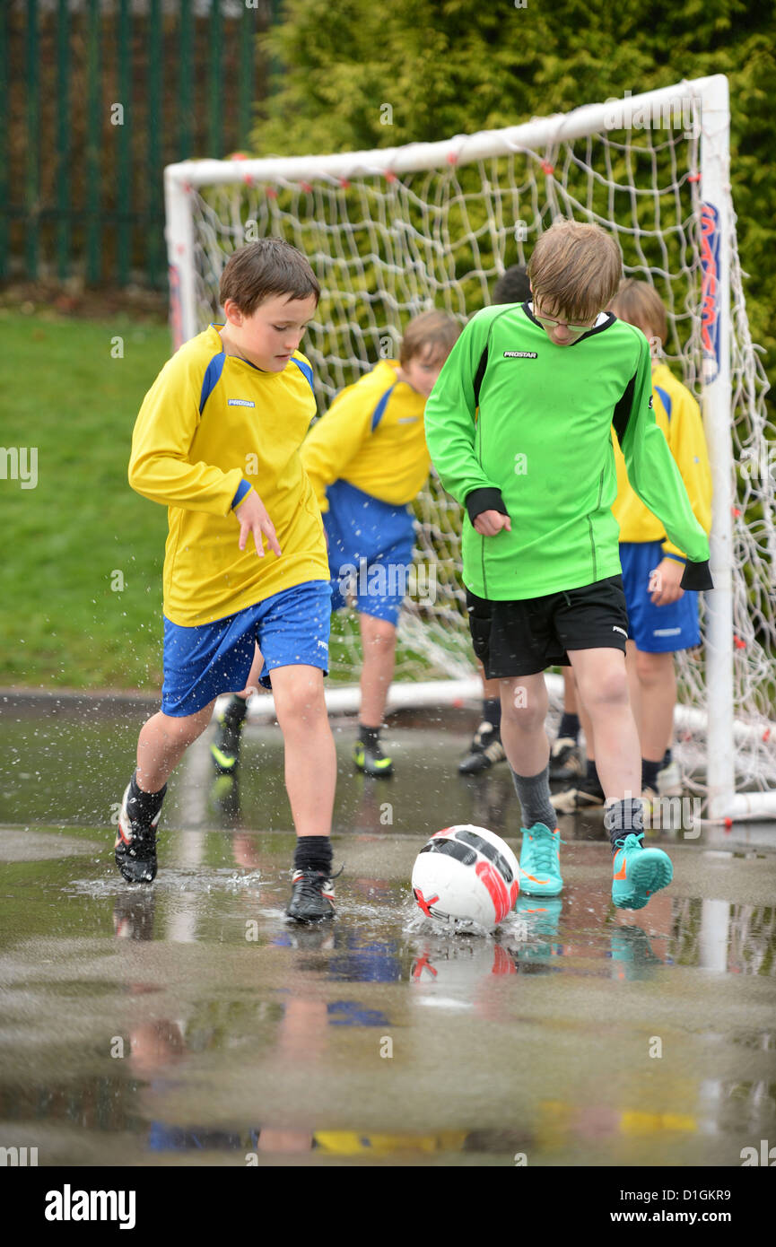Kids Playing Soccer In The Rain