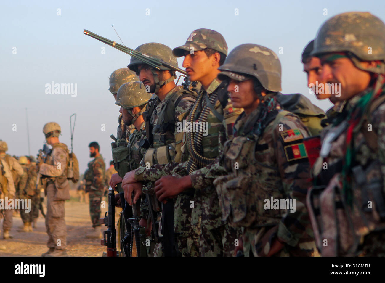 Afghan National Army soldiers wait for orders to move out on a clearing ...