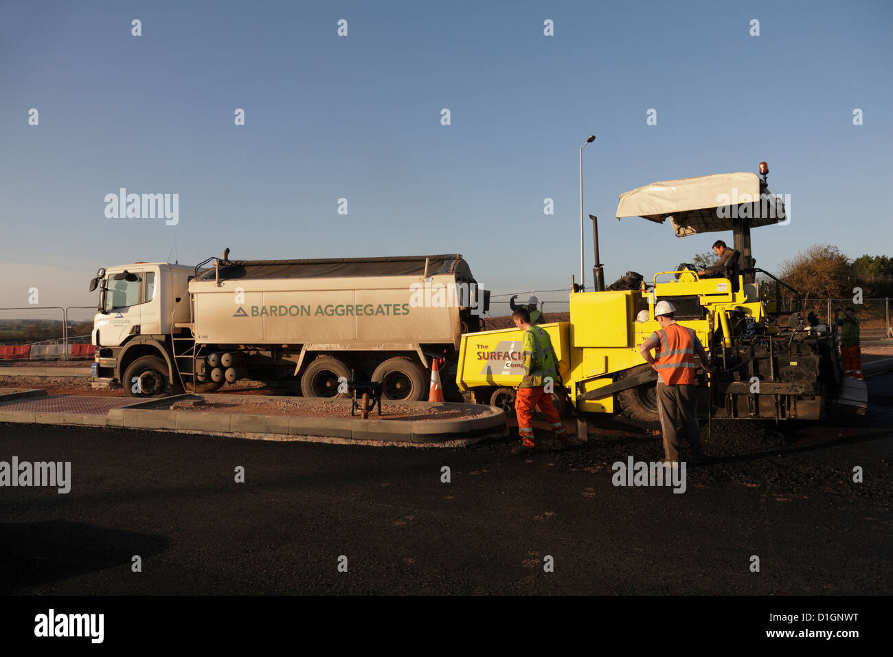 A Civil Engineering contractor highway maintenance gang laying asphalt ...
