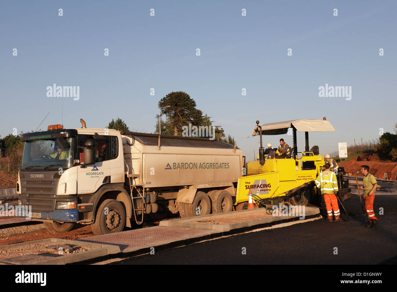 A Civil Engineering contractor highway maintenance gang laying asphalt ...