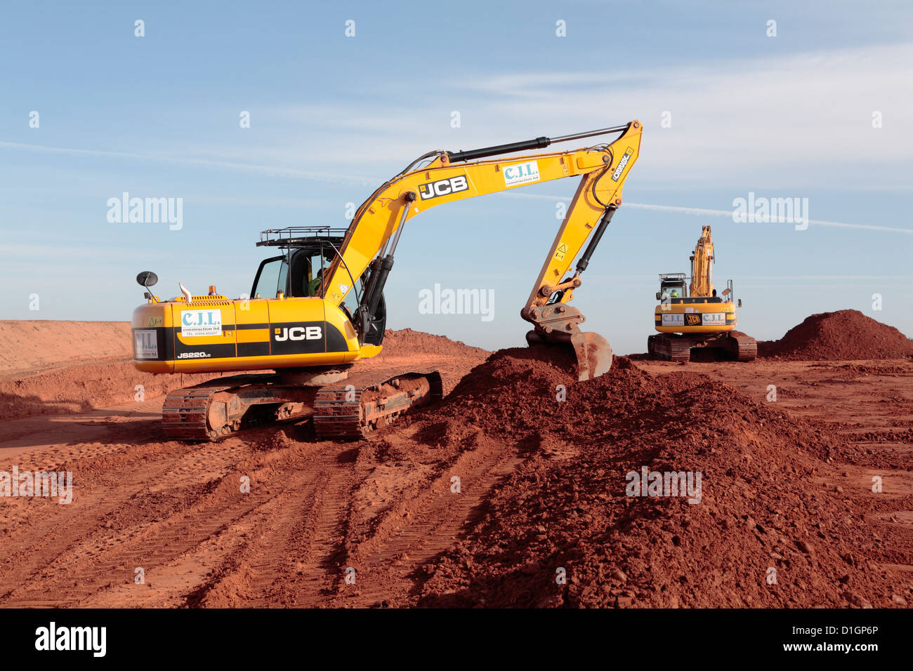 Large tracked digger diggers heavy plant machinery excavating soil on ...