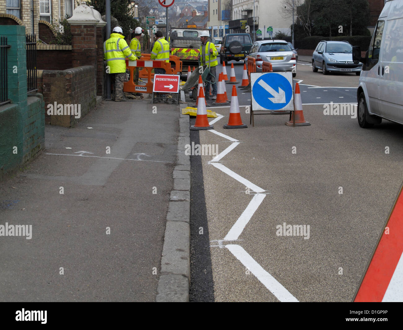Road sign approaching urban roadworks site on busy road traffic ...